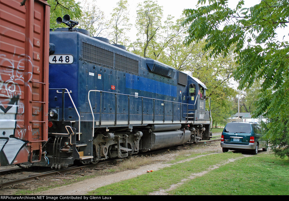 MNA 448 waits for the conductor to throw the switch in between two houses